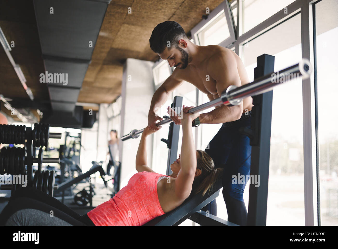Personal trainer helping woman reach goals in gym Stock Photo - Alamy