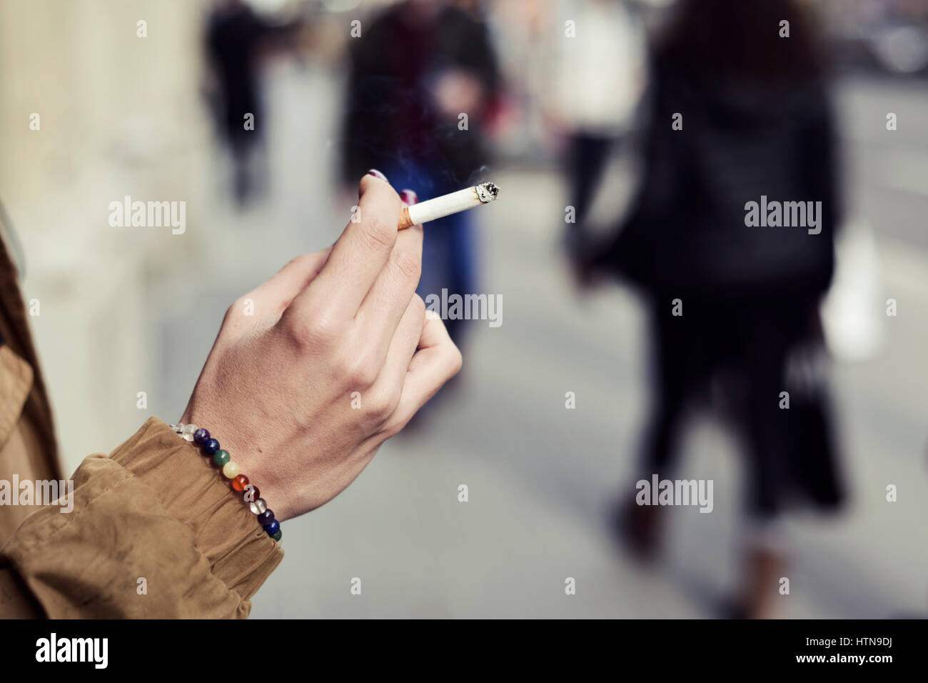 closeup of a young caucasian woman with purple nail polish in her ...