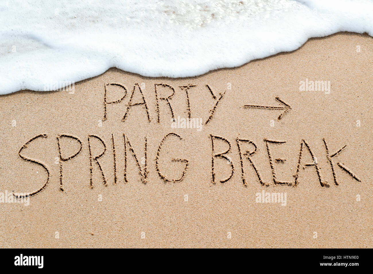 closeup of an arrow sign and the text party spring break written in the ...