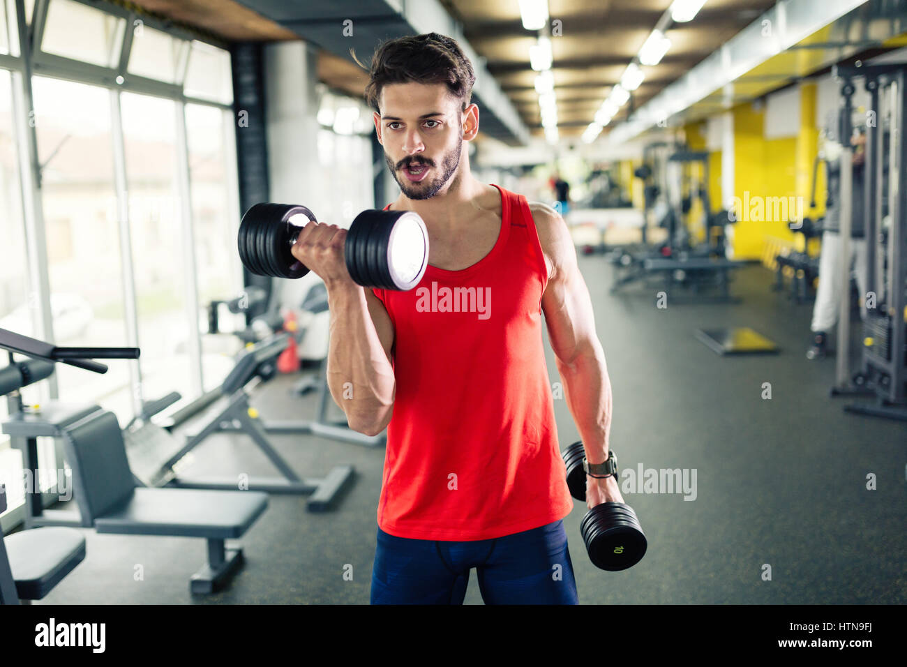 Determined male working out in gym lifting weights Stock Photo - Alamy Determined male working out in gym lifting weights Stock Photo - Alamy