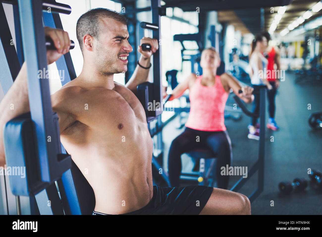 Determined people training and working out in gym Stock Photo - Alamy