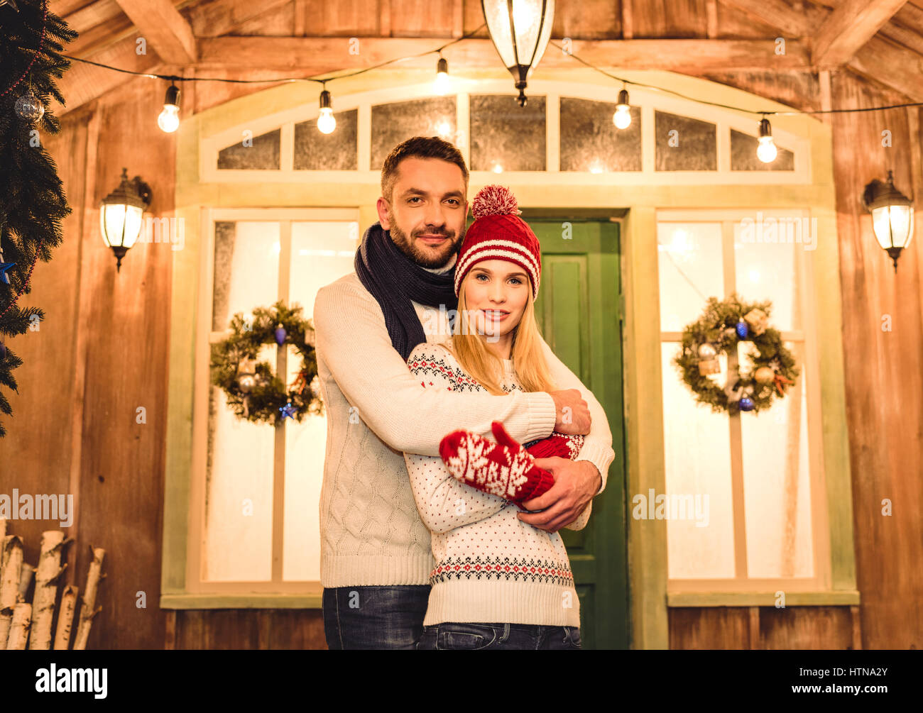 Couple in knitted sweaters hugging Stock Photo - Alamy