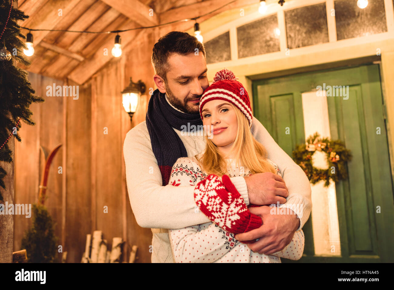 Couple in knitted sweaters hugging Stock Photo - Alamy