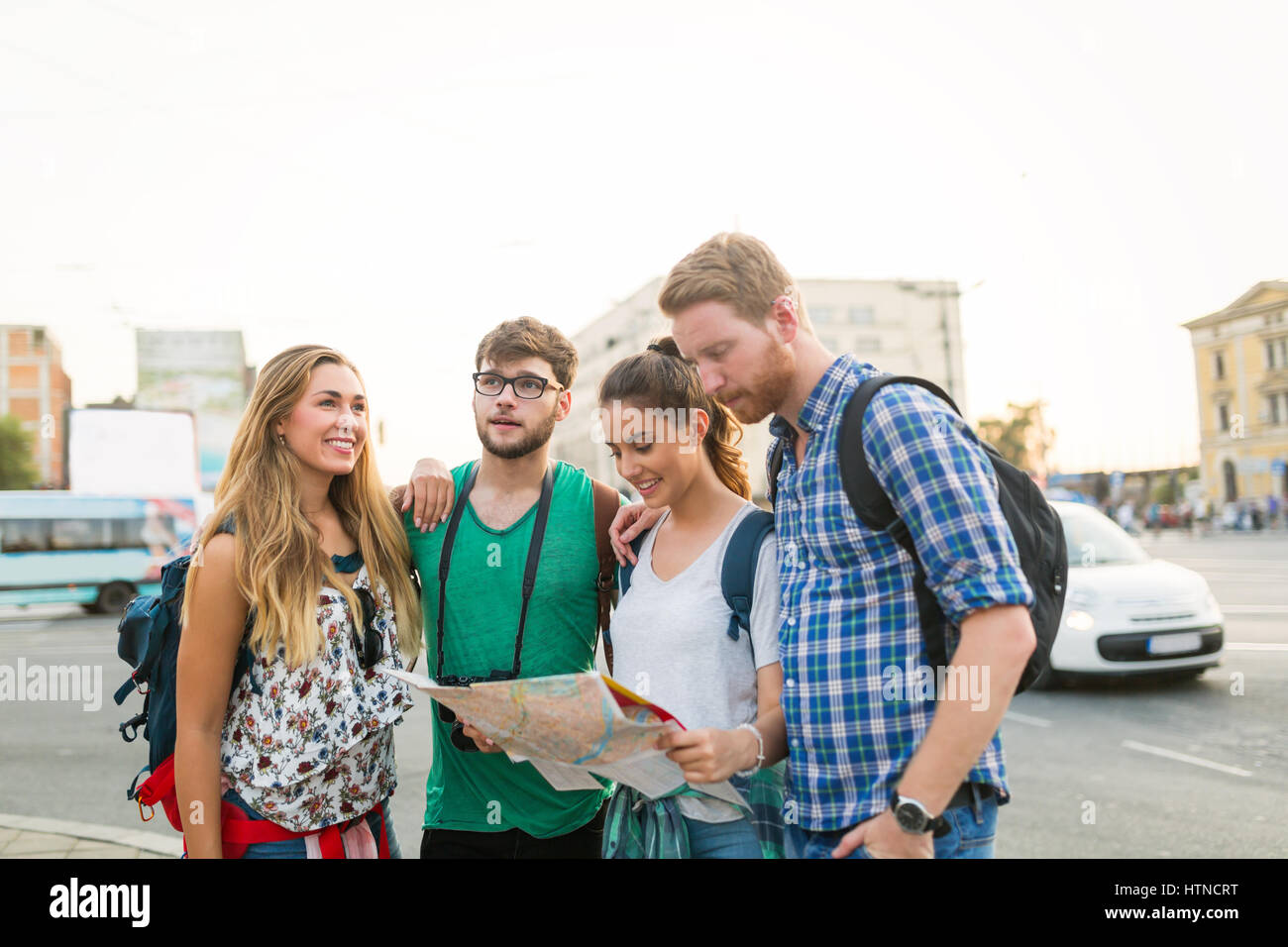 Happy tourists traveling and sightseeing in city Stock Photo - Alamy