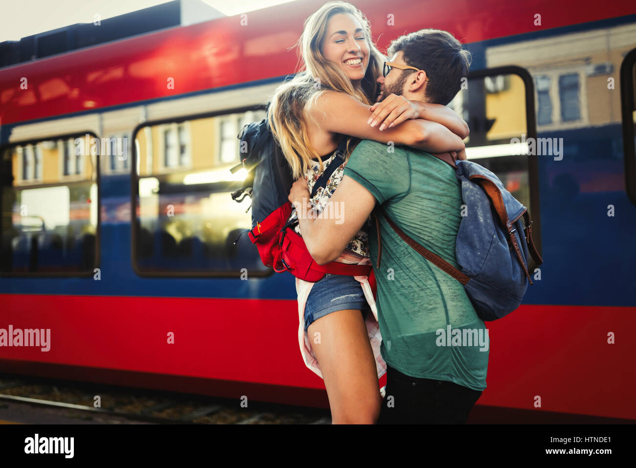 Couple in love reunion after traveler arrives Stock Photo - Alamy