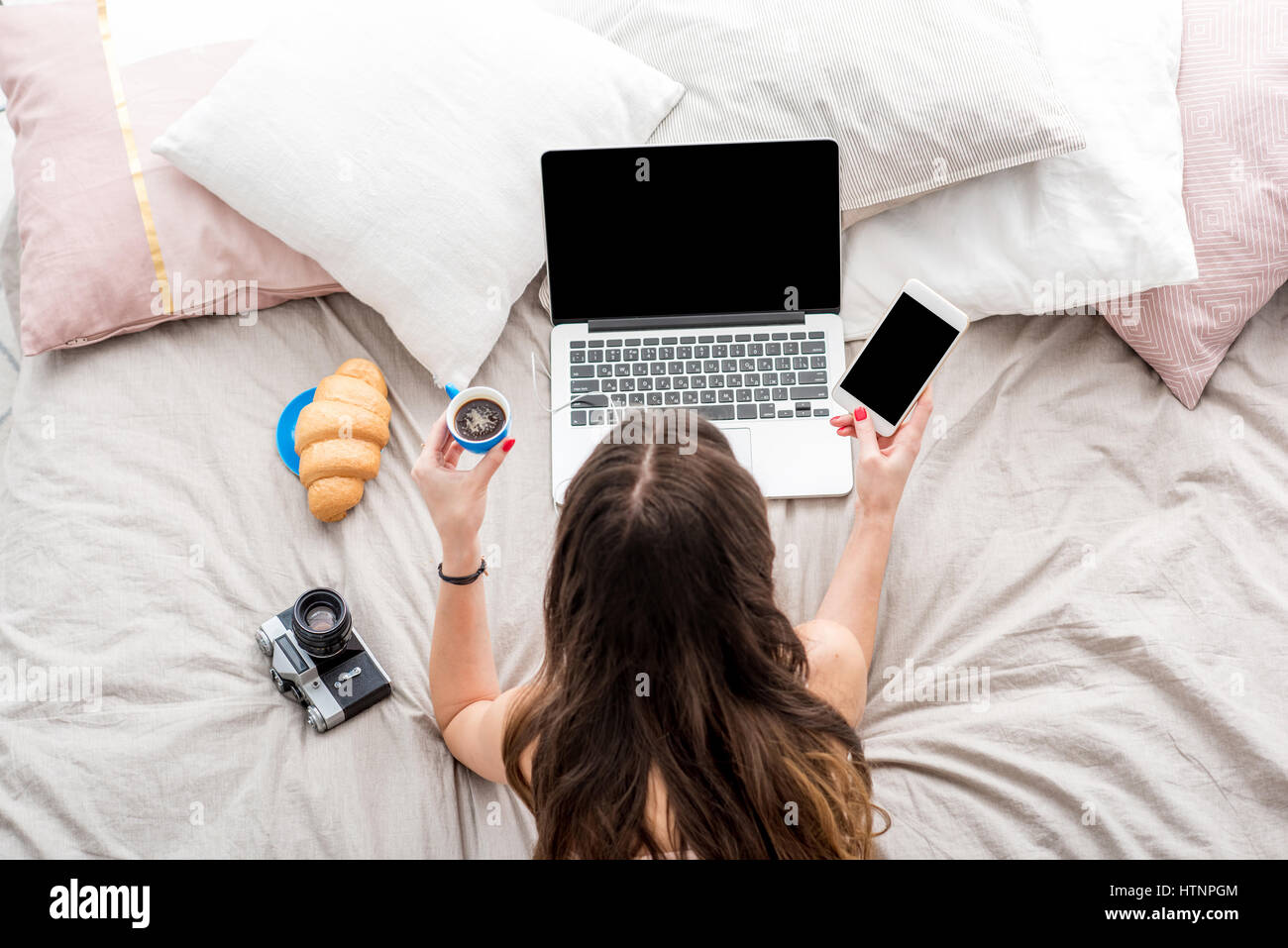 Woman with laptop on the bed Stock Photo - Alamy