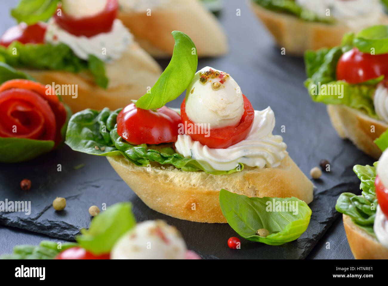 Delicious cold starters: Slices of baguette with cherry tomato ...