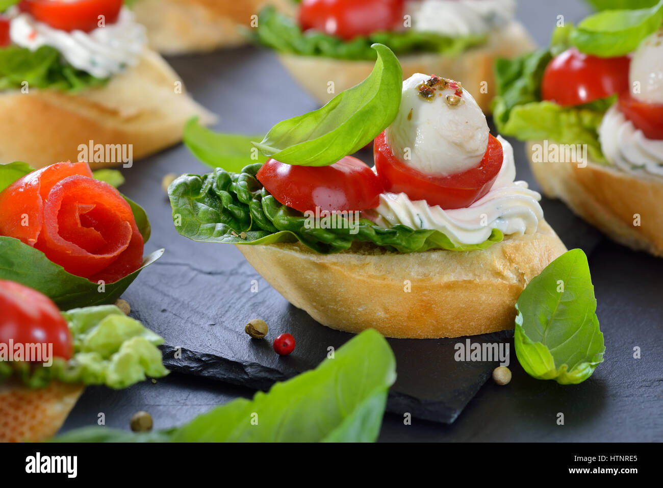Delicious cold starters: Slices of baguette with cherry tomato ...
