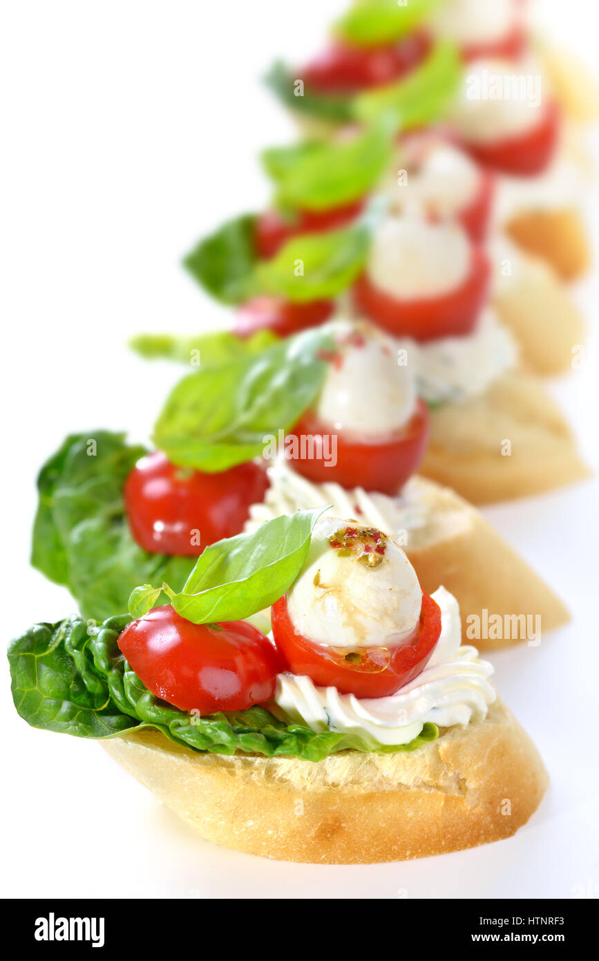 Delicious cold starters: Slices of baguette with cherry tomato ...