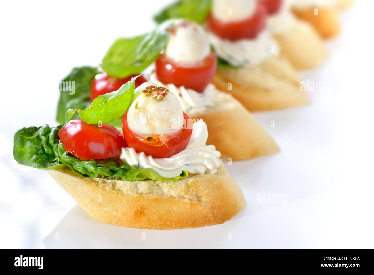 Delicious cold starters: Slices of baguette with cherry tomato ...