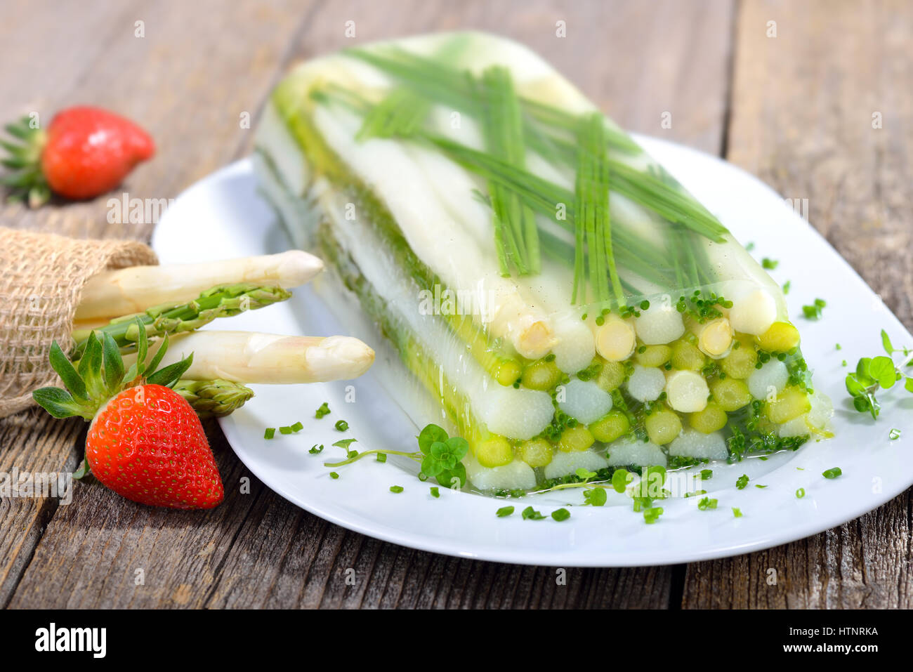 Vegetable jelly with fresh white and green asparagus and chives Stock ...