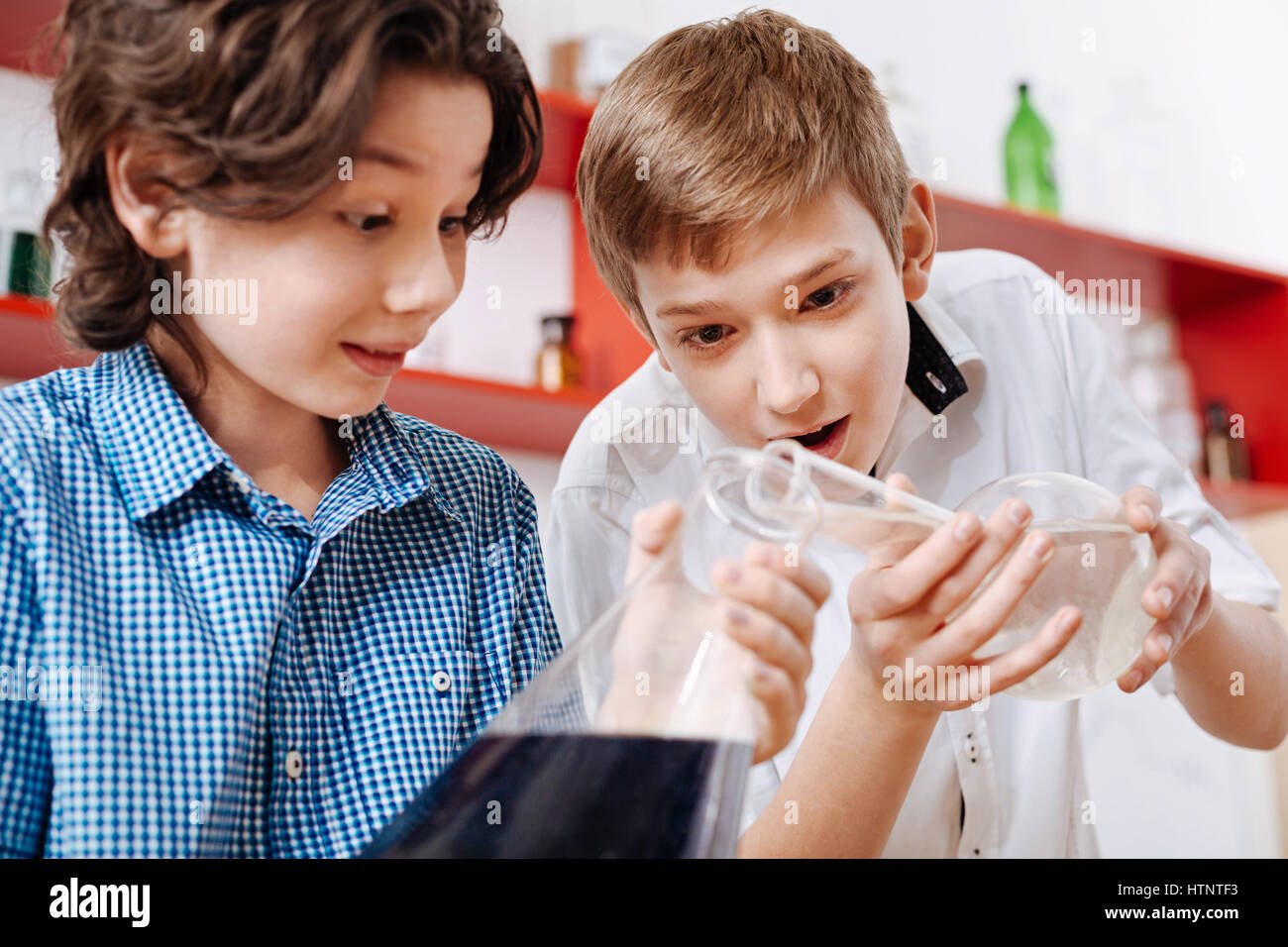 Chemistry project. Nice intelligent exited boys carrying out an ...