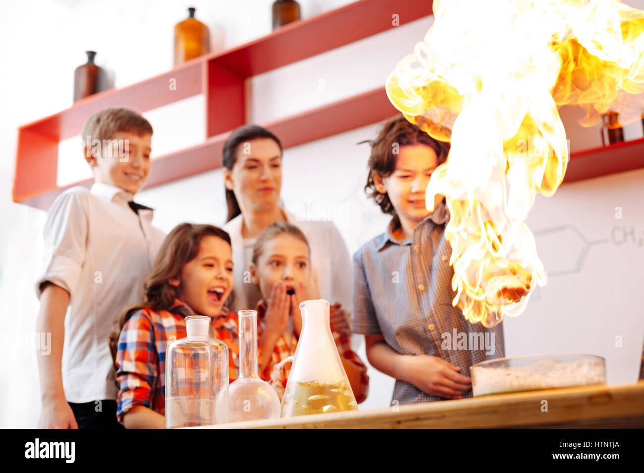 How dangerous. Surprised nice cute children standing in the chemistry ...