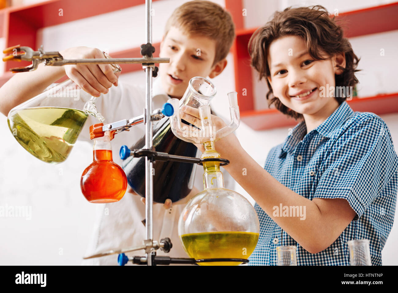 After lessons. Positive curious smart boys smiling and enjoying their ...