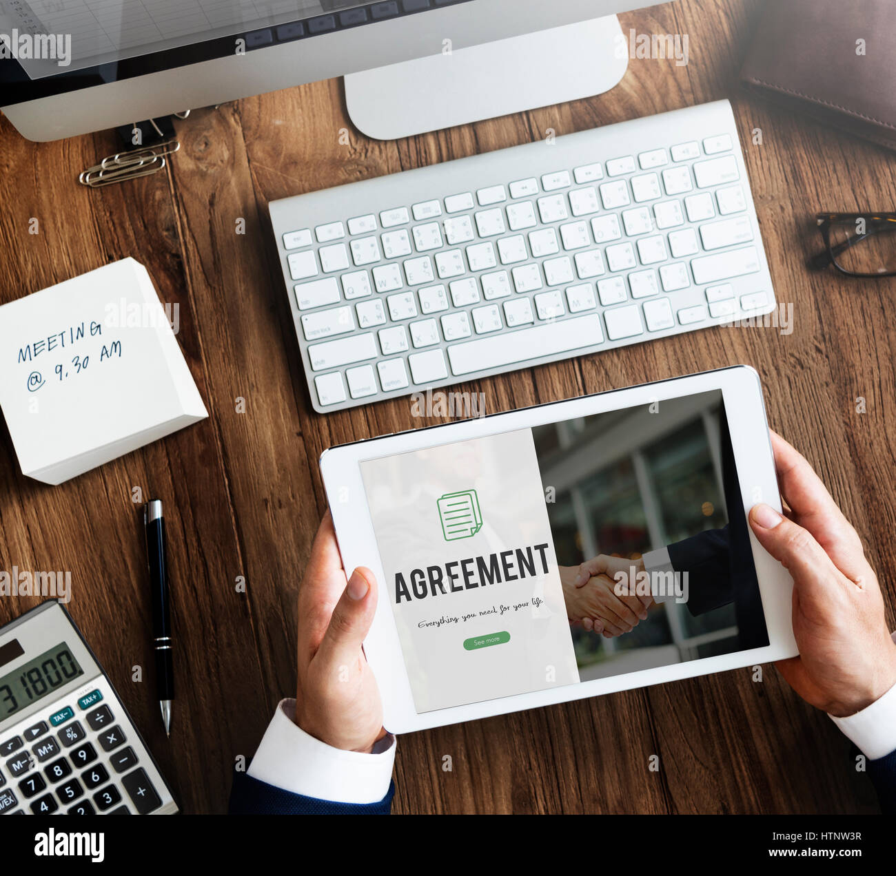 Agreement word on business handshake background Stock Photo - Alamy