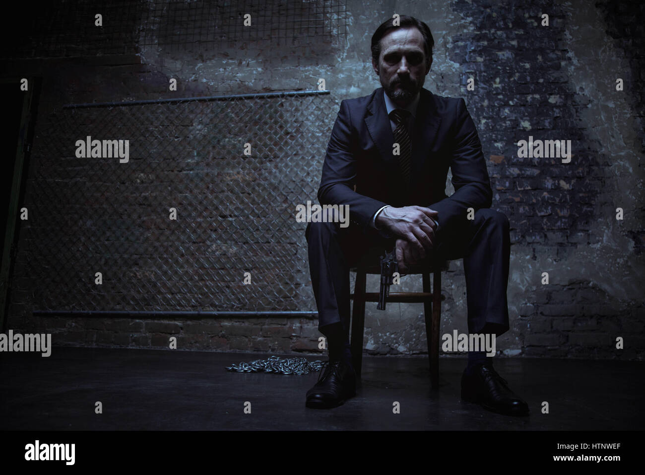 Danger vibes. Handsome smart evil man wearing an expensive suit looking ...