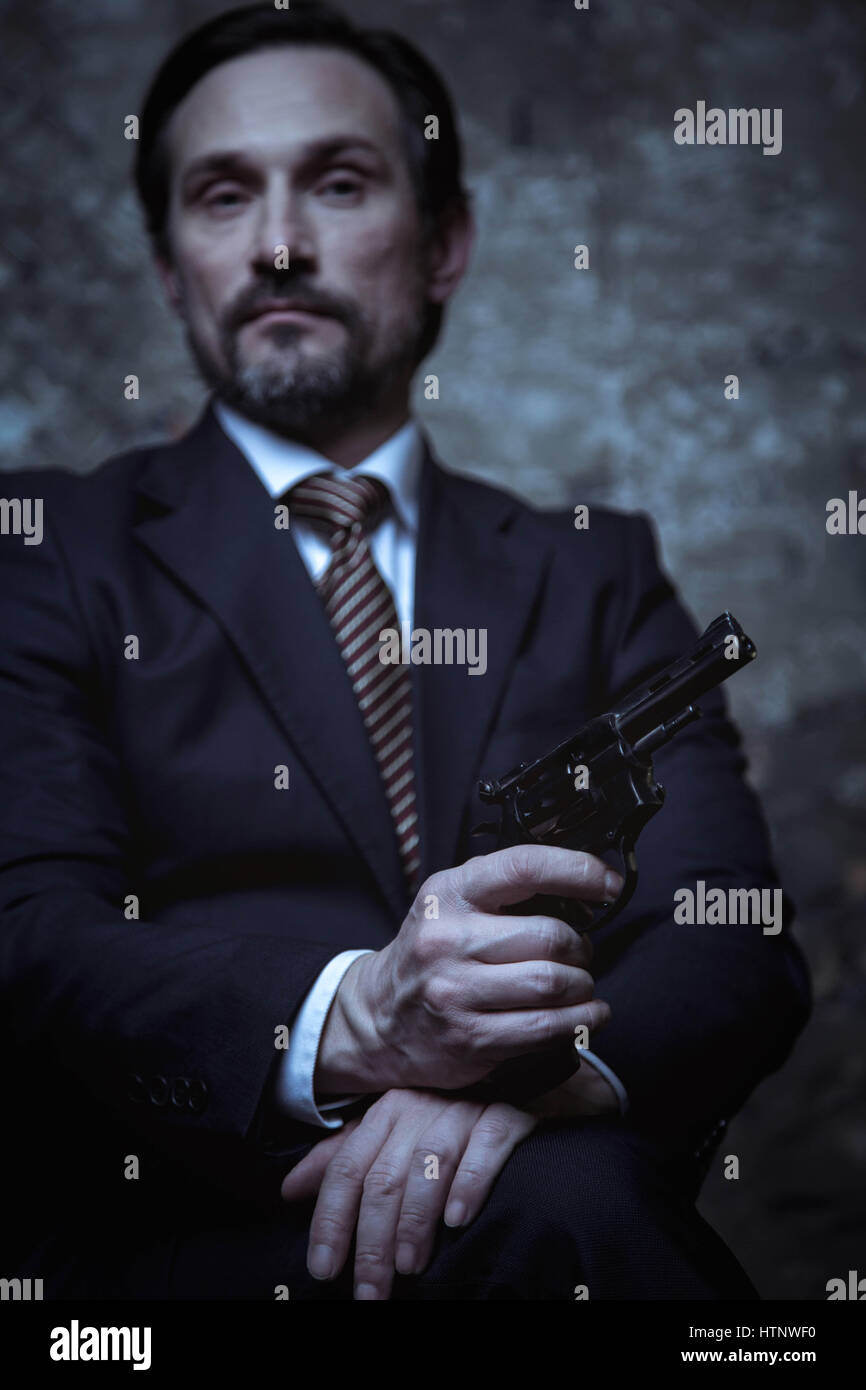 Crime lord. Handsome powerful charismatic man looking unimpressed while ...