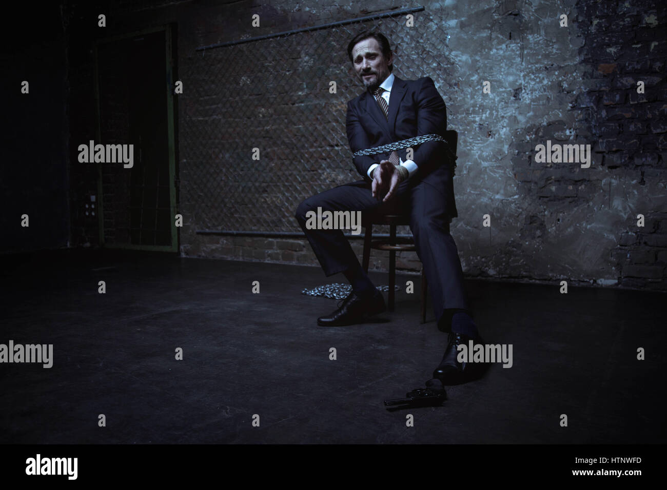 Almost got it. Desperate scared trapped man trying getting a weapon ...