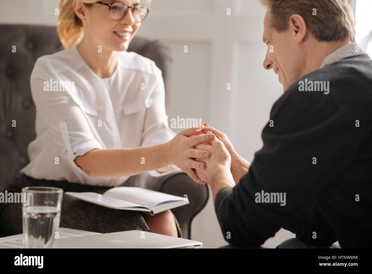 Kinesthetic communication. Cheerful positive professional therapist ...