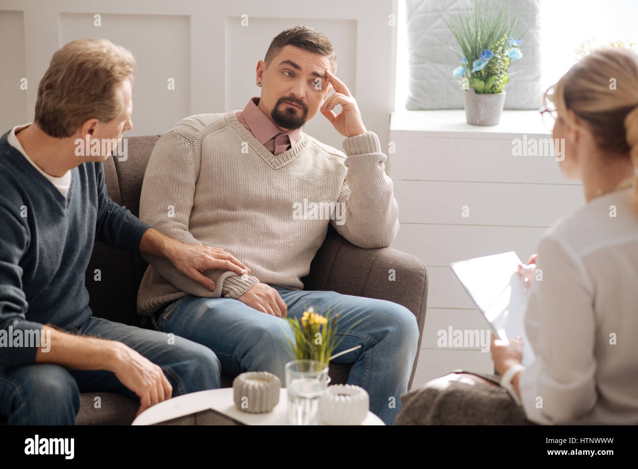 Life under stress. Handsome thoughtful moody man sitting with his ...