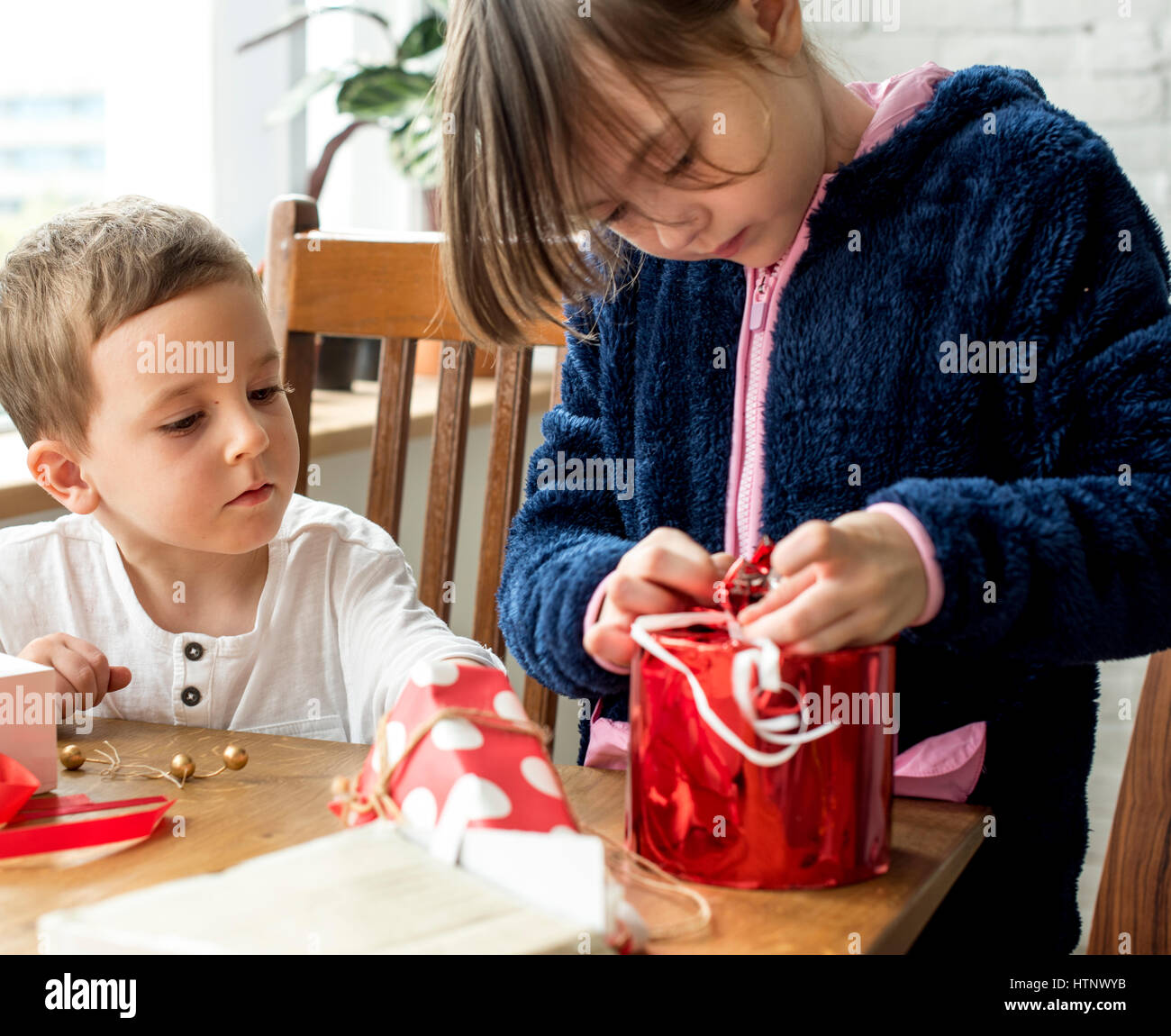 Little Children Wrapping Present Smiling Stock Photo - Alamy