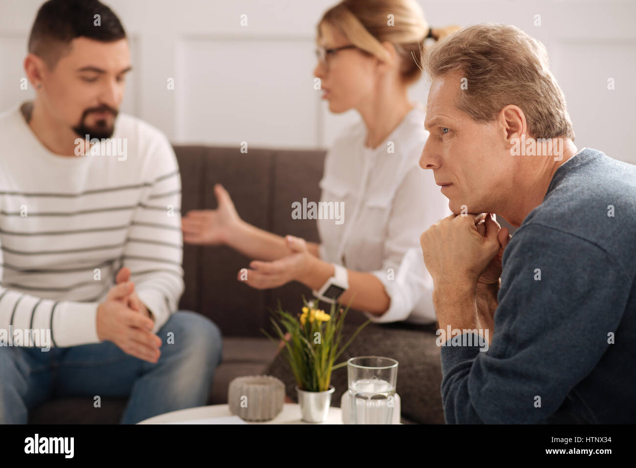 How to cope with problems. Unhappy gloomy handsome man holding his chin ...