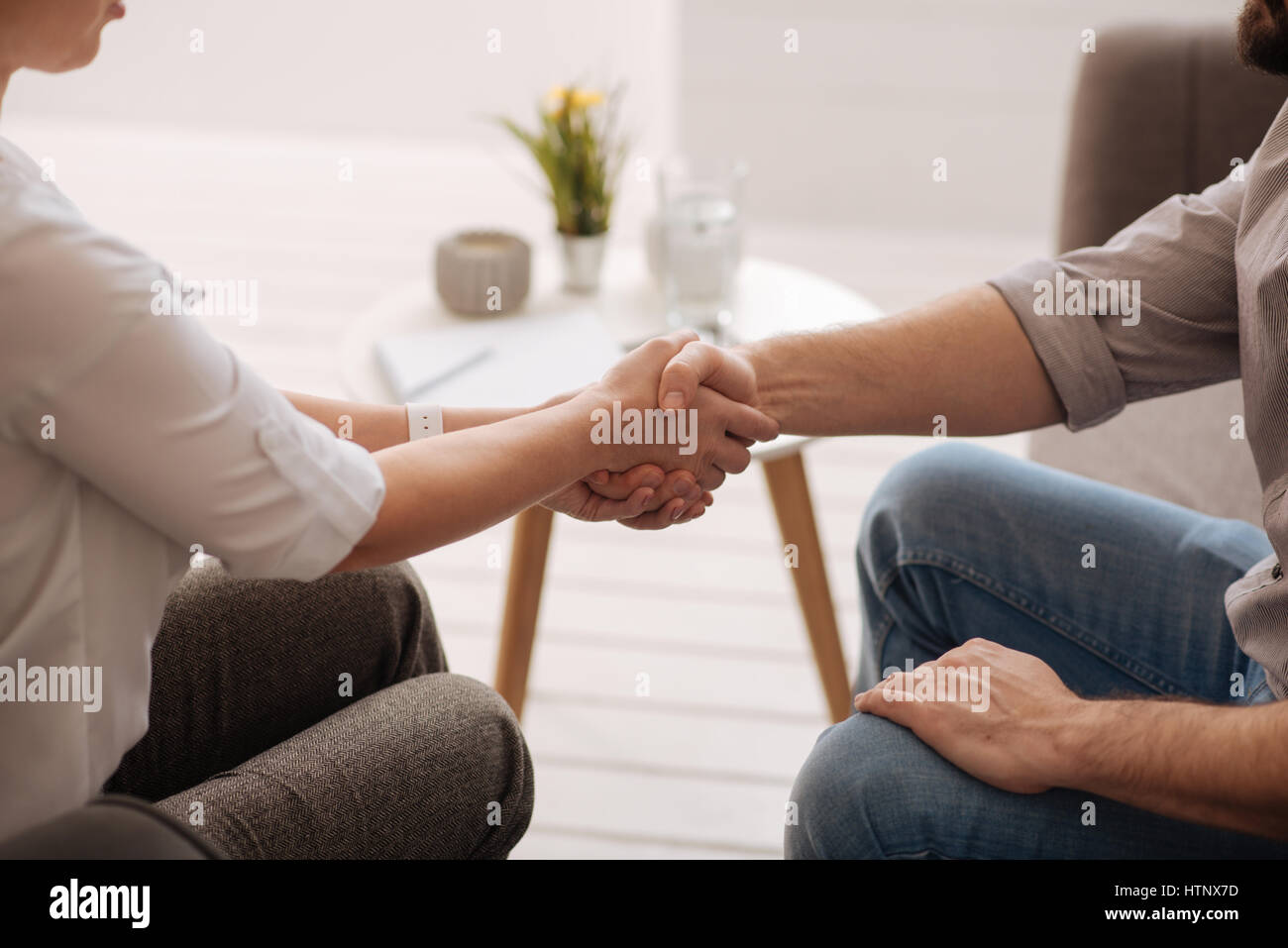 Greeting each other. Close up of a handshake of two people while ...