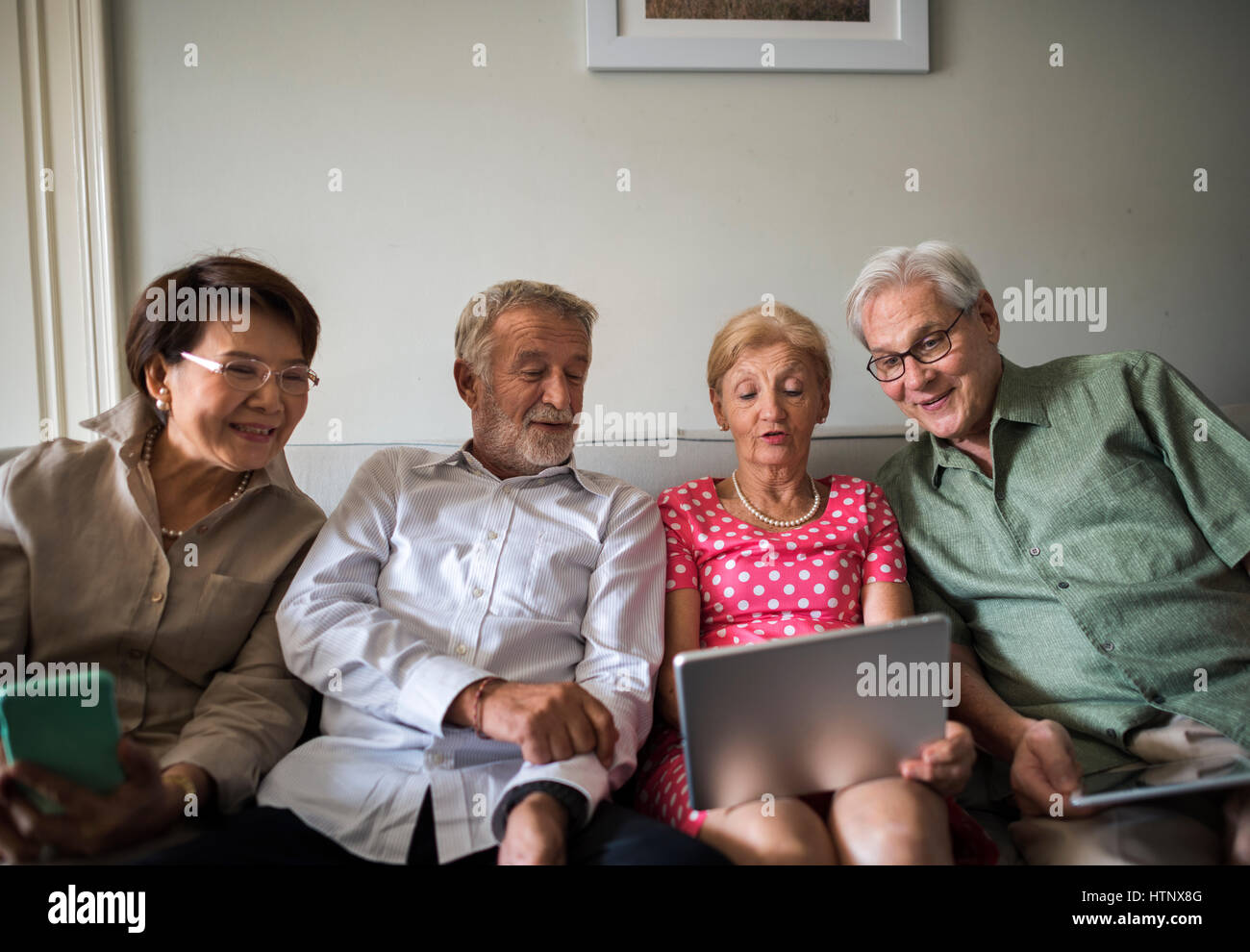 Senior Adult Use Tablet Mobile Phone Technology Stock Photo - Alamy