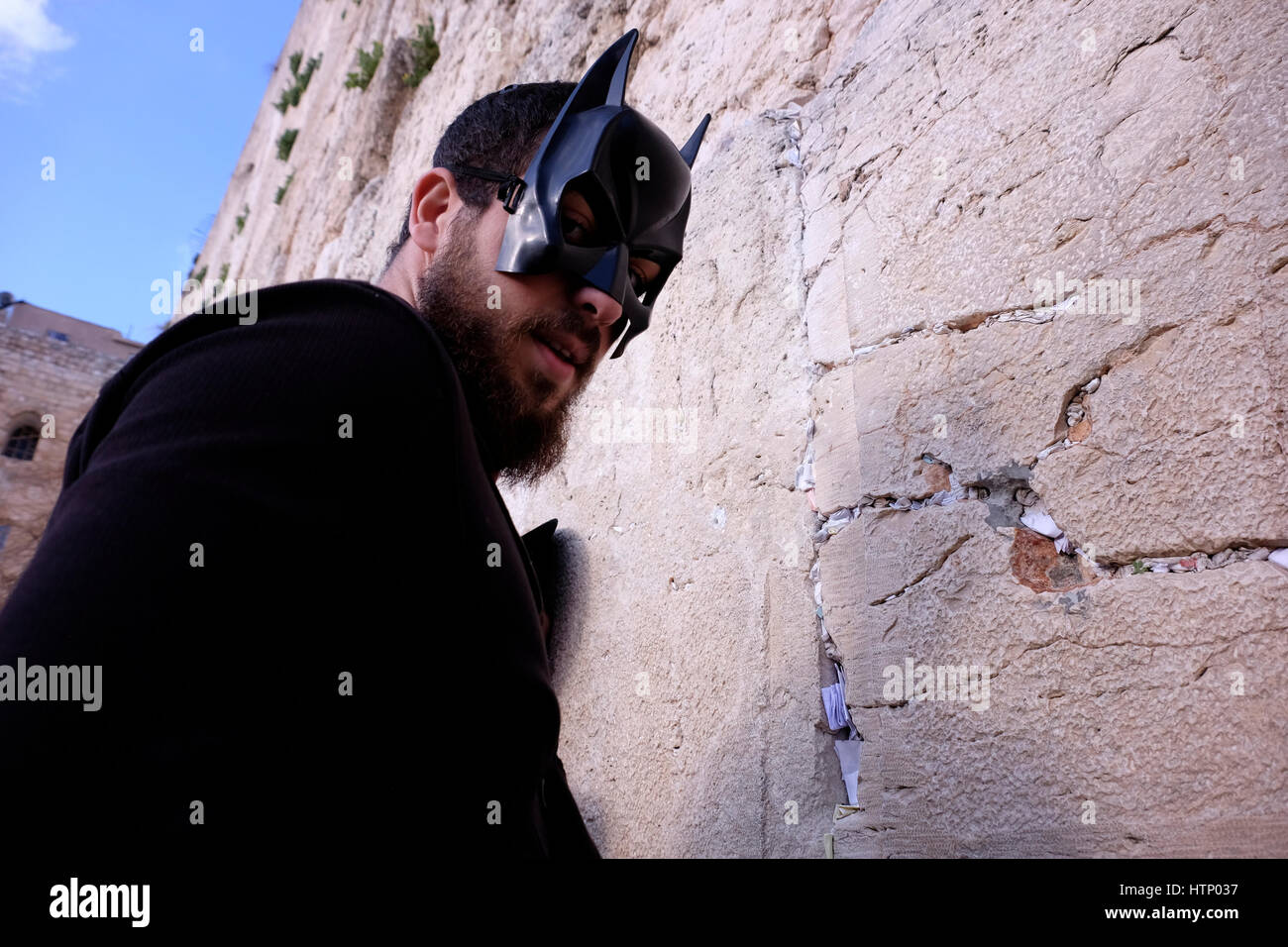 A religious Jew wearing Batman mask during the Jewish festival of Purim ...