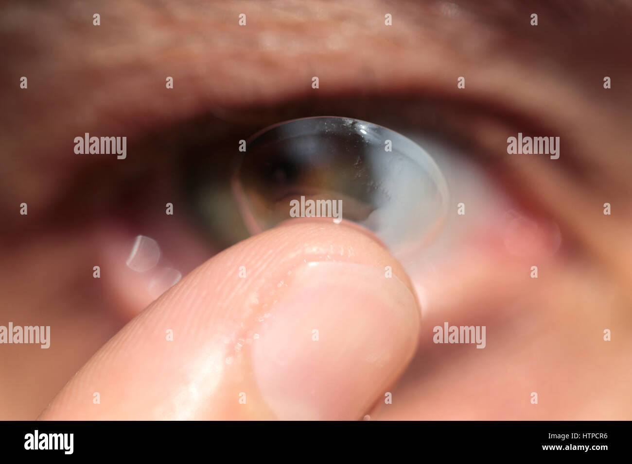 Placement of contact lenses on eye Stock Photo - Alamy
