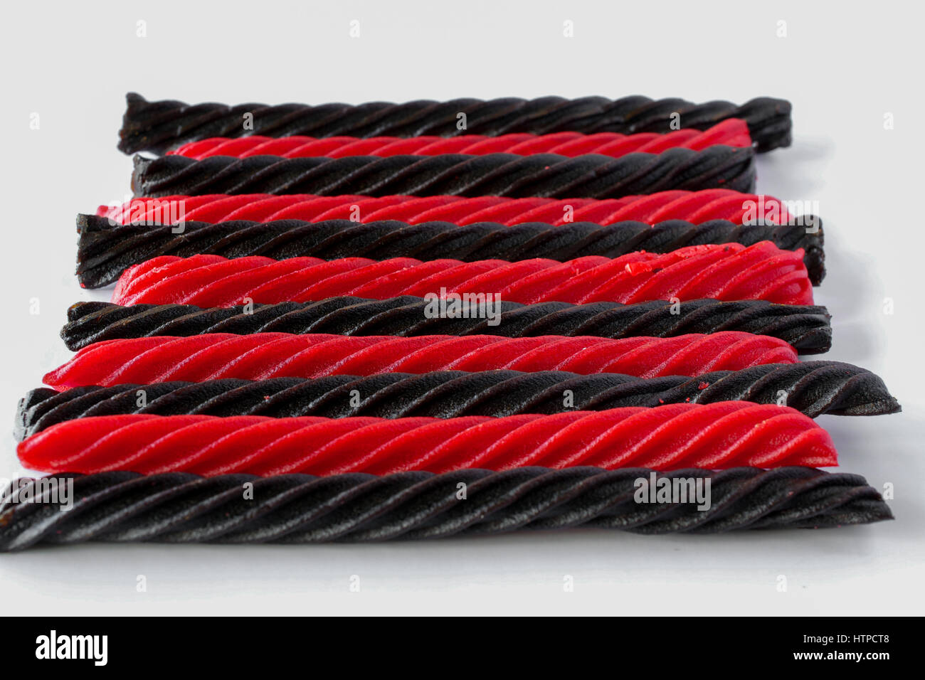 Alternating Red and Black liquorice candy bars laid flat on white ... Alternating Red and Black liquorice candy bars laid flat on white ...