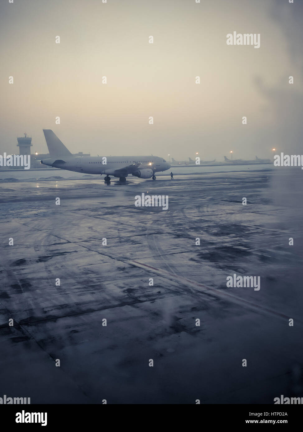 Color shot of a commercial airplane on the runaway, on a cold winter ...