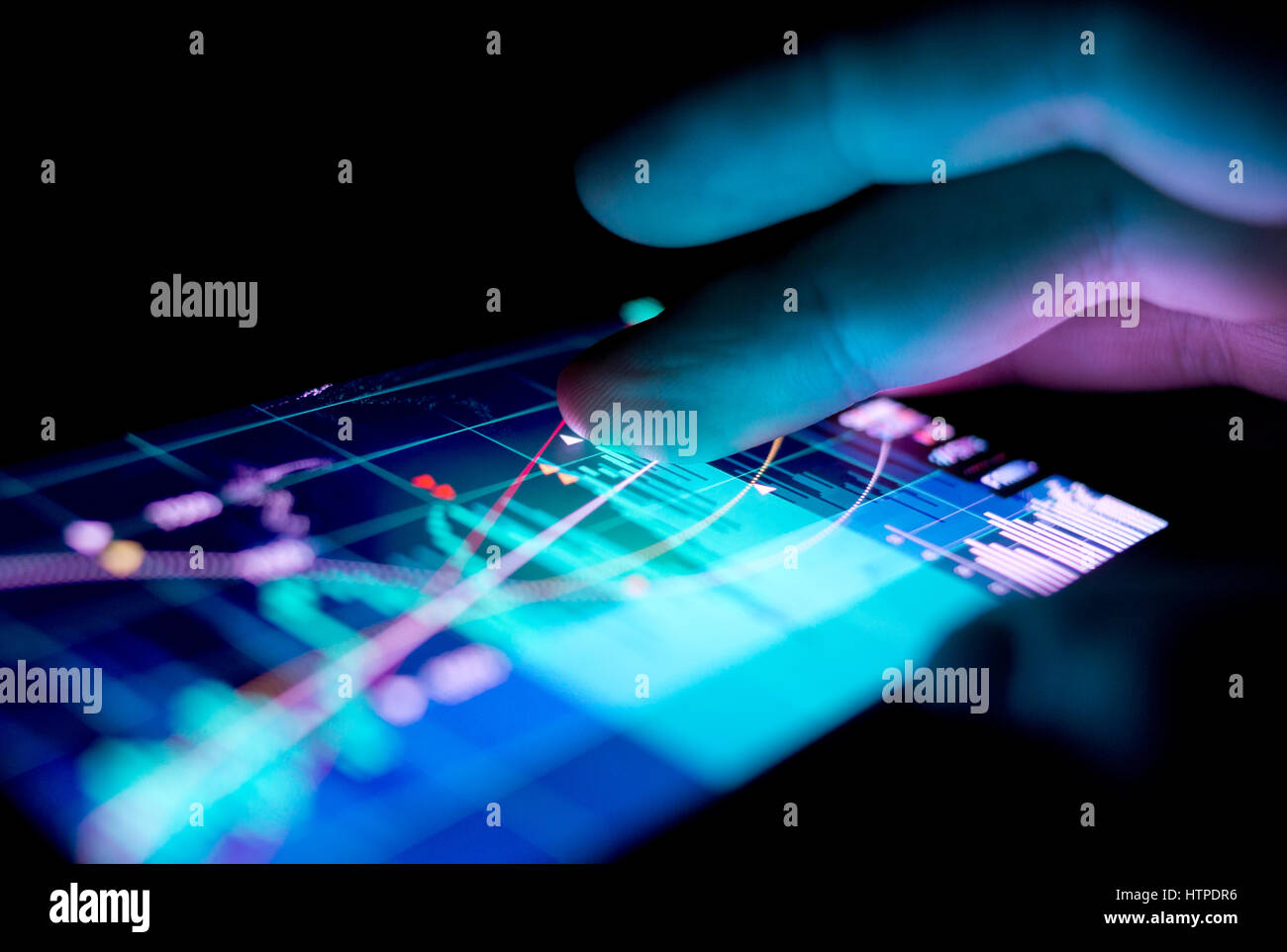 A businessman checking stock charts on a mobile device. Technology and ...