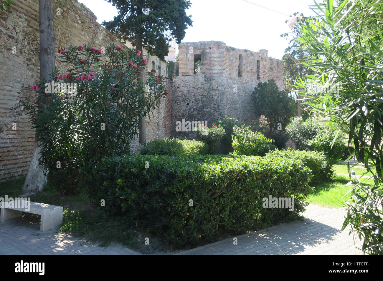 Shrubbery and trees at the wall at entrance to remains of ancient ...