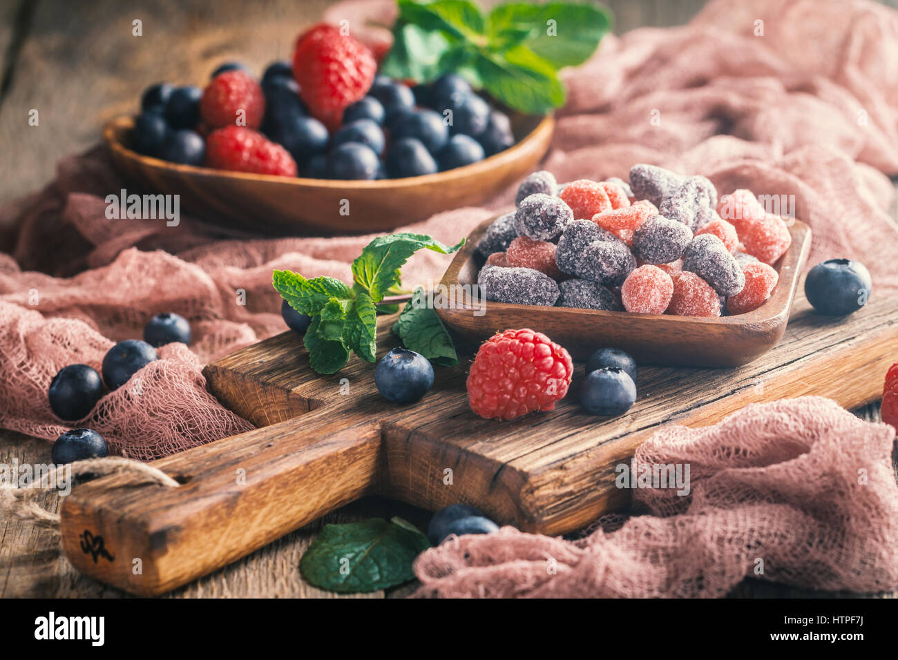 Dried and candied fruits and berries in wooden bowl with fresh ...