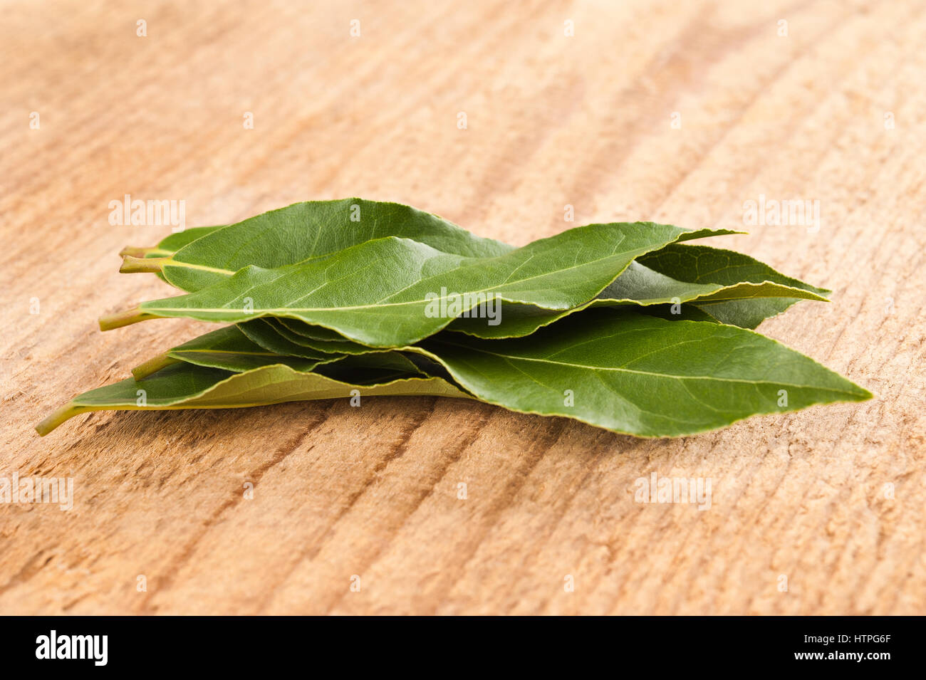 Laurel leaves on wood background Stock Photo - Alamy