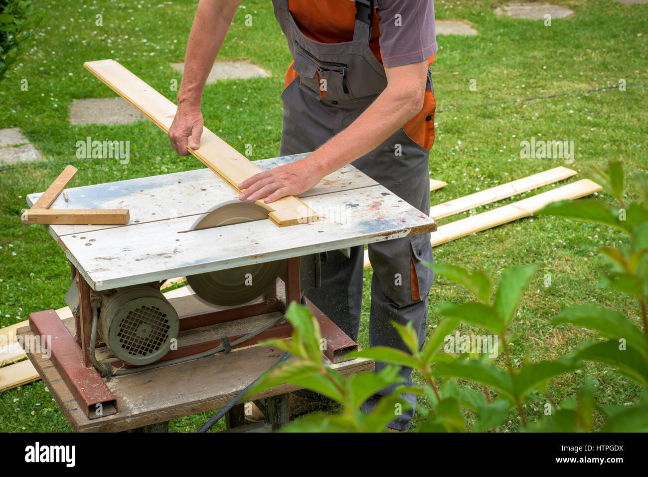 Carpenter working with electric buzz saw cutting wooden boards Stock ...