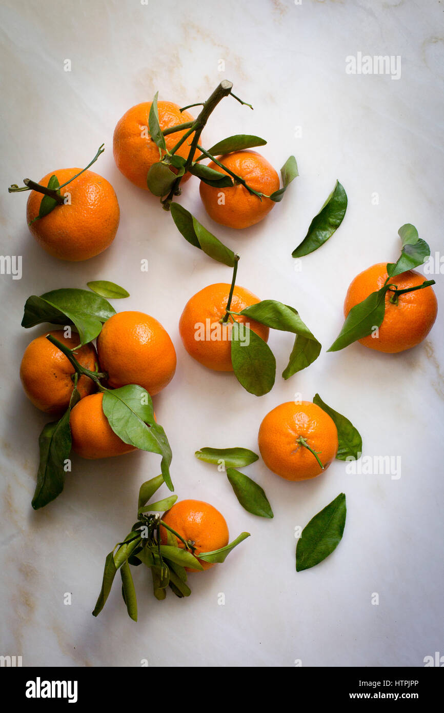 Tangerines with leaves and stem Stock Photo - Alamy
