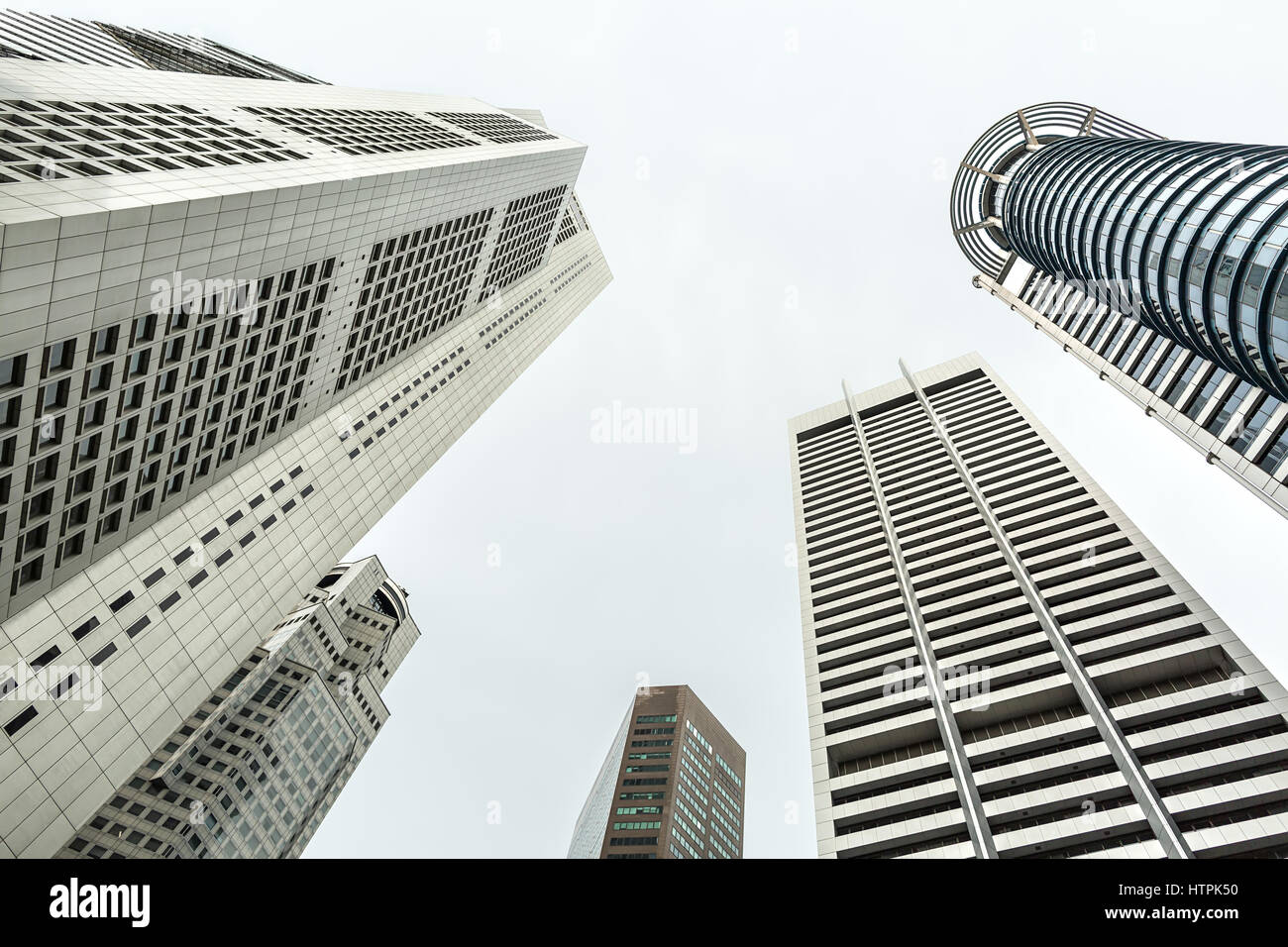 Several skyscrapers on the sky background in Singapore. View from below ...