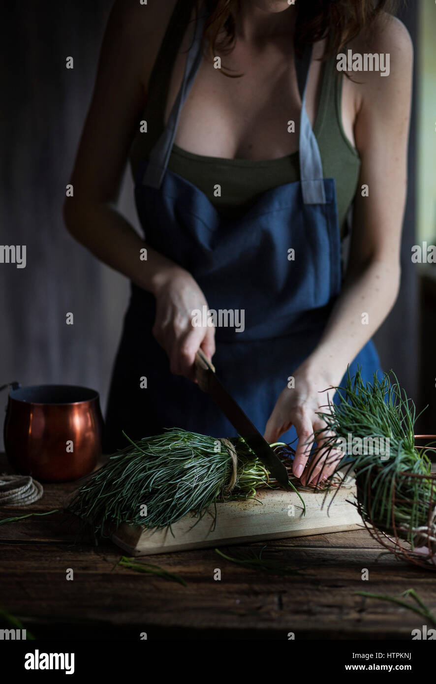 Woman cutting agretti, a typical italian spring vegetables Stock Photo ...