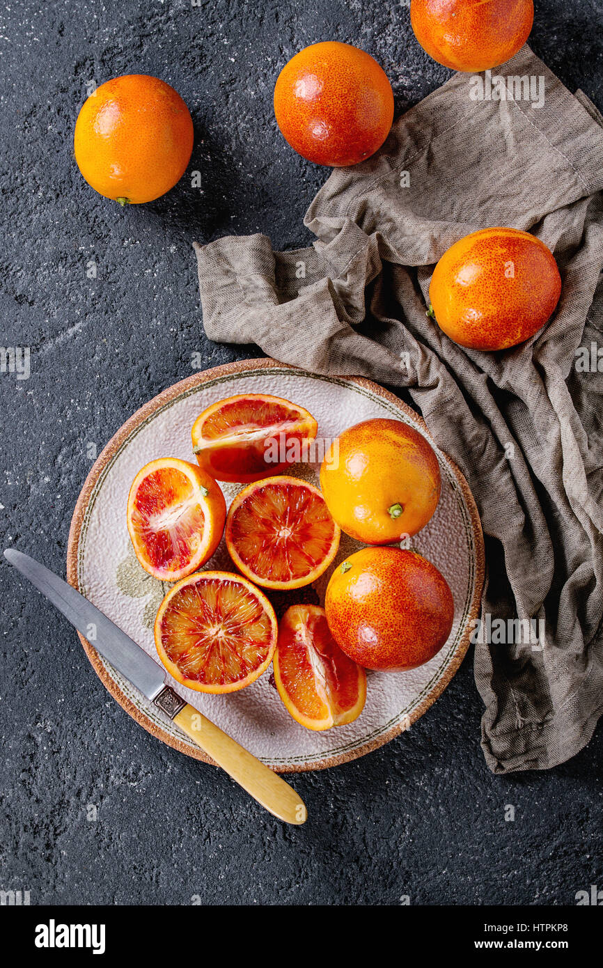 Sliced and whole ripe juicy Sicilian Blood oranges fruits with knife ...