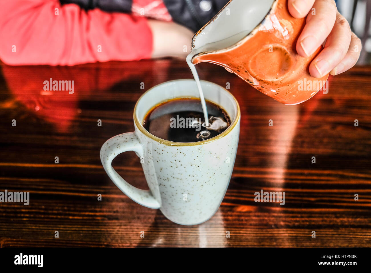 Pouring Cream Into Coffee