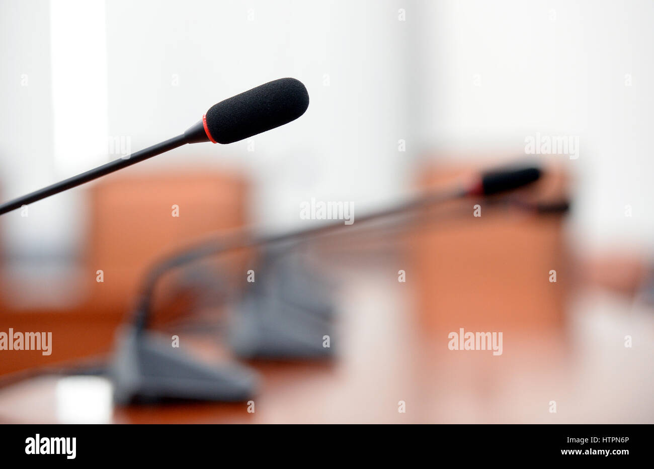 close up of a microphone in empty conference hall Stock Photo - Alamy