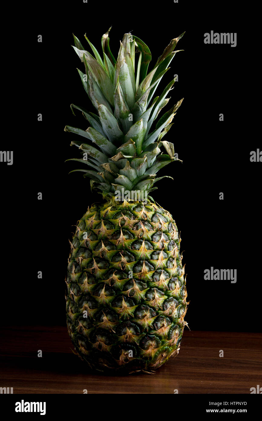 Pineapple on black isolated background Stock Photo - Alamy