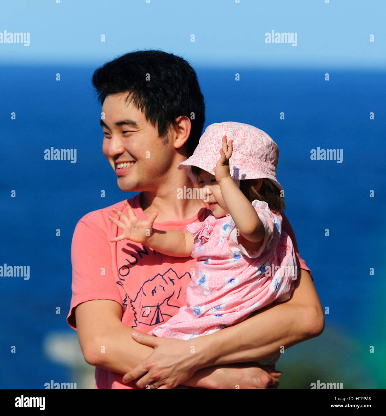 Father carrying child in arms hi-res stock photography and images - Alamy