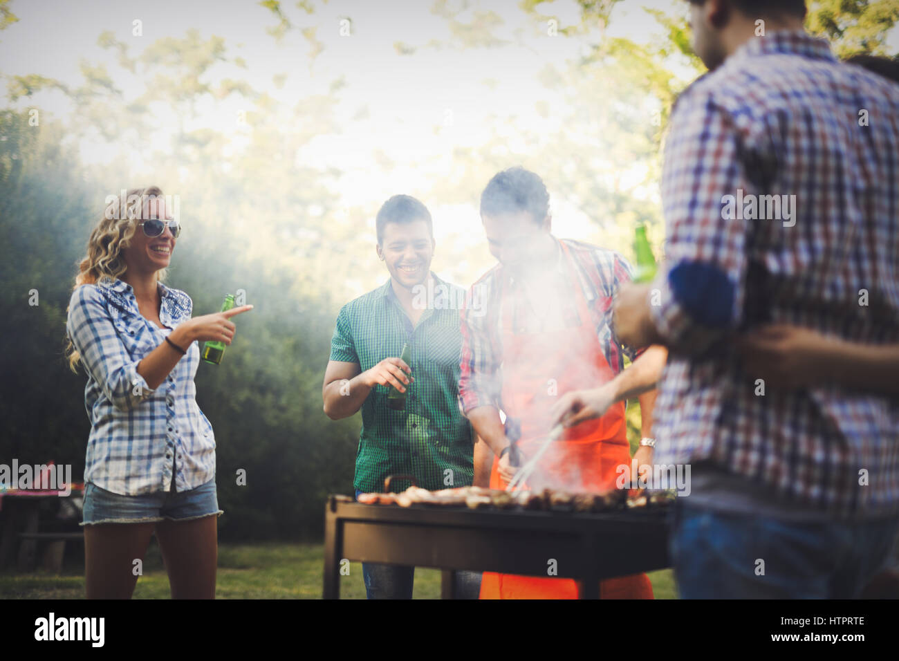 Happy people having camping and having bbq party outdoor Stock Photo ...