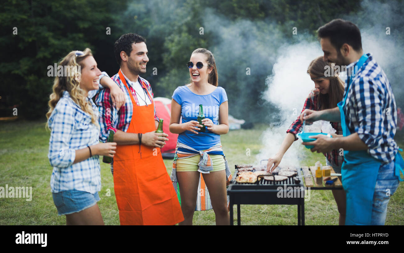 Friends having fun grilling meat enjoying bbq party Stock Photo - Alamy