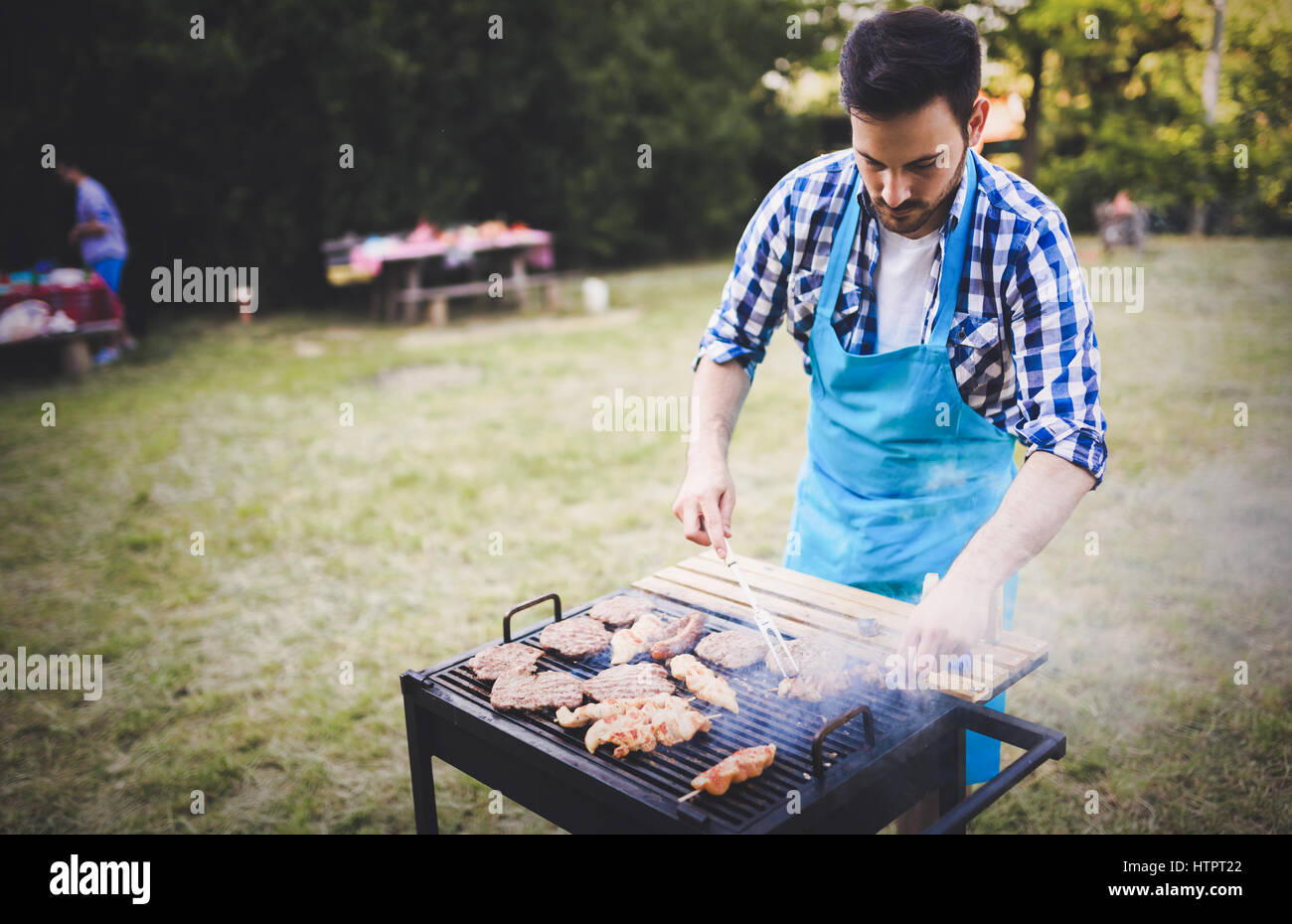 Happy male grilling bbq meat outdoor in nature Stock Photo - Alamy