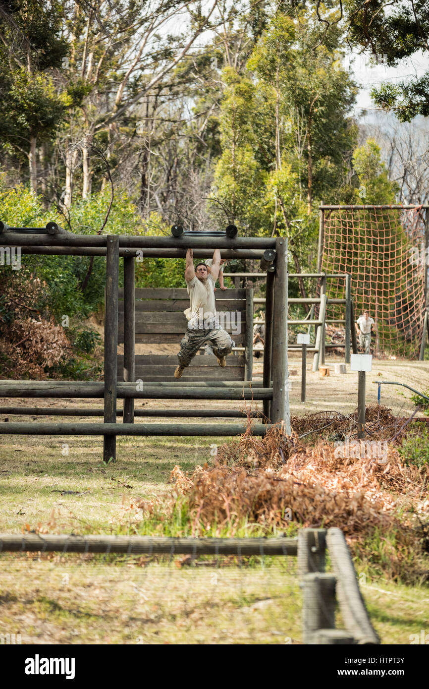 Soldier running through obstacle course in boot camp Stock Photo - Alamy