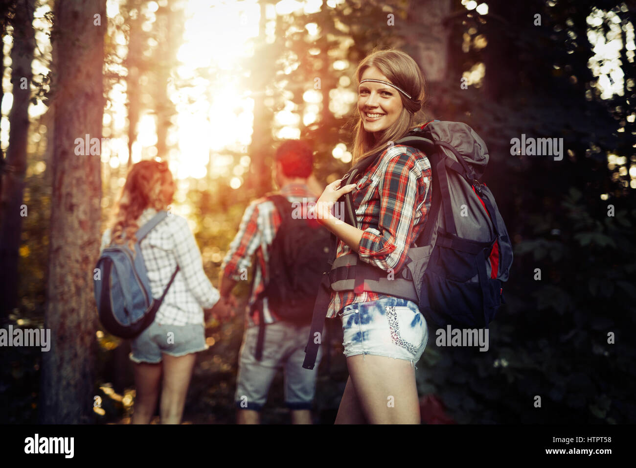 Group of backpacking hikers friends going for forest trekking Stock ...